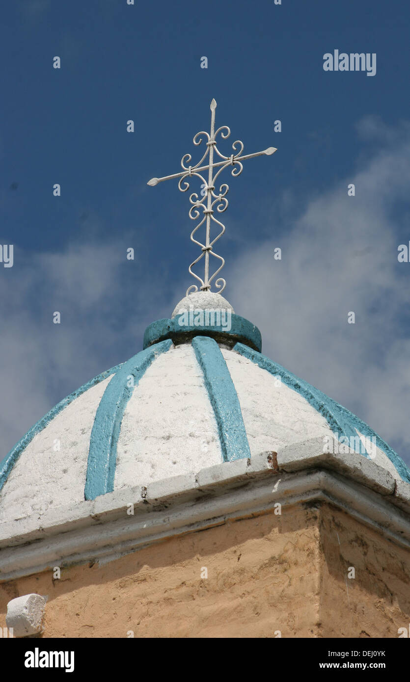 A steel painted cross on the dome of a small church in Cotacachi ...