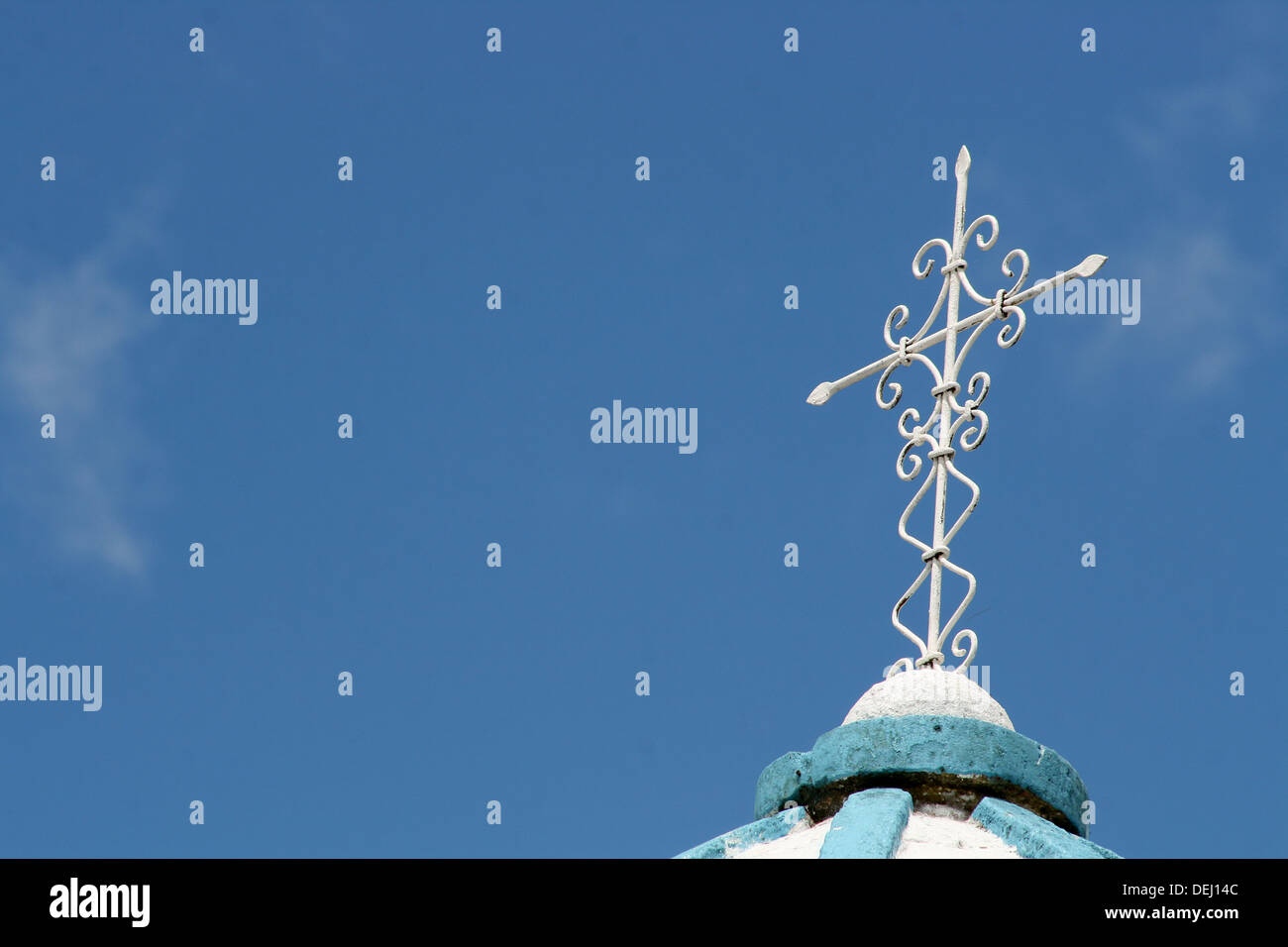 A steel painted cross on the dome of a small church in Cotacachi ...