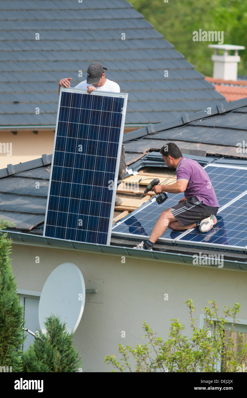 Installation of photovoltaic solar panels on roof of house, Germany ...