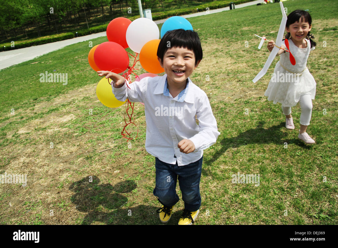 Oriental children playing outdoors Stock Photo - Alamy