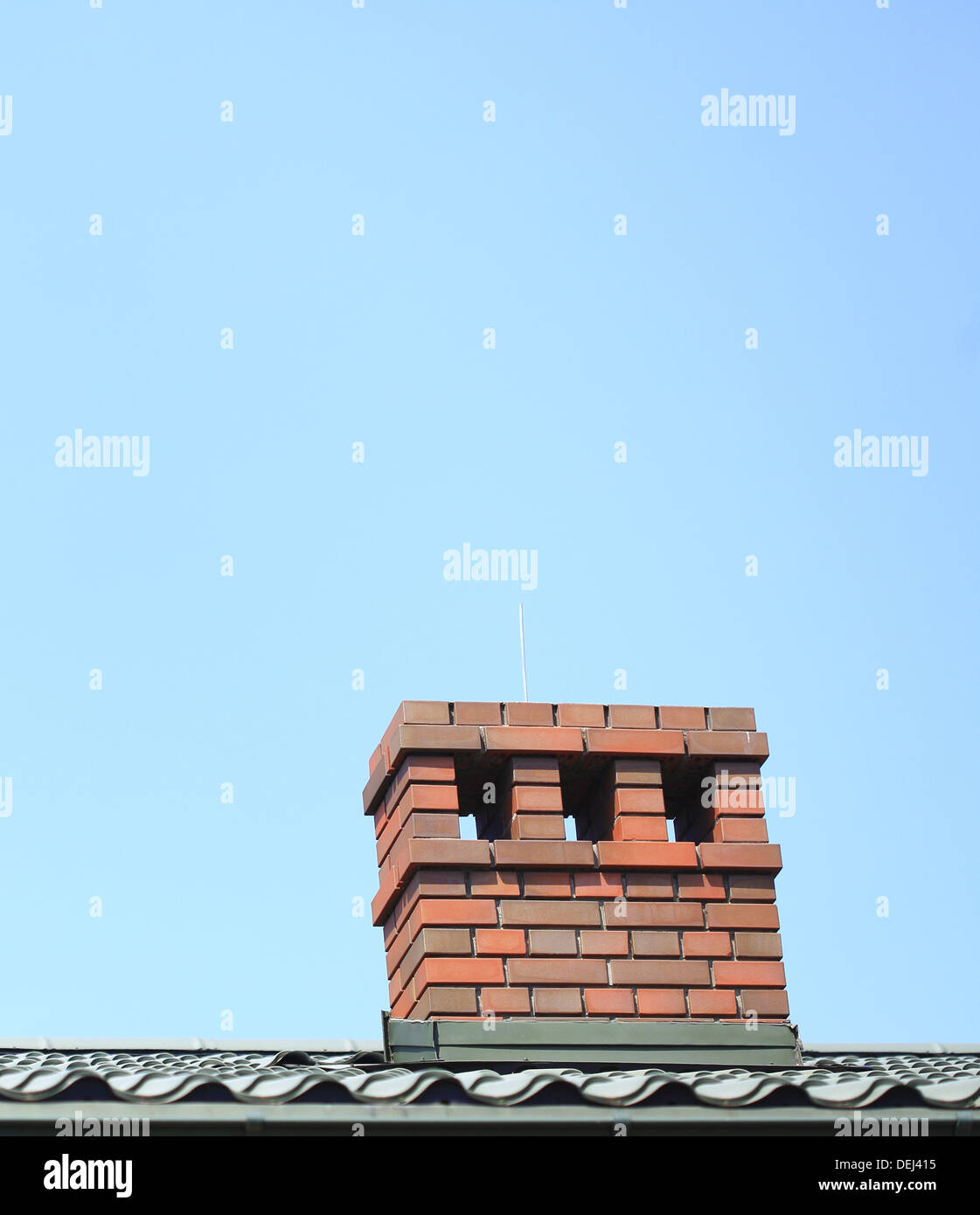 Red chimney on the roof blue sky background Stock Photo - Alamy