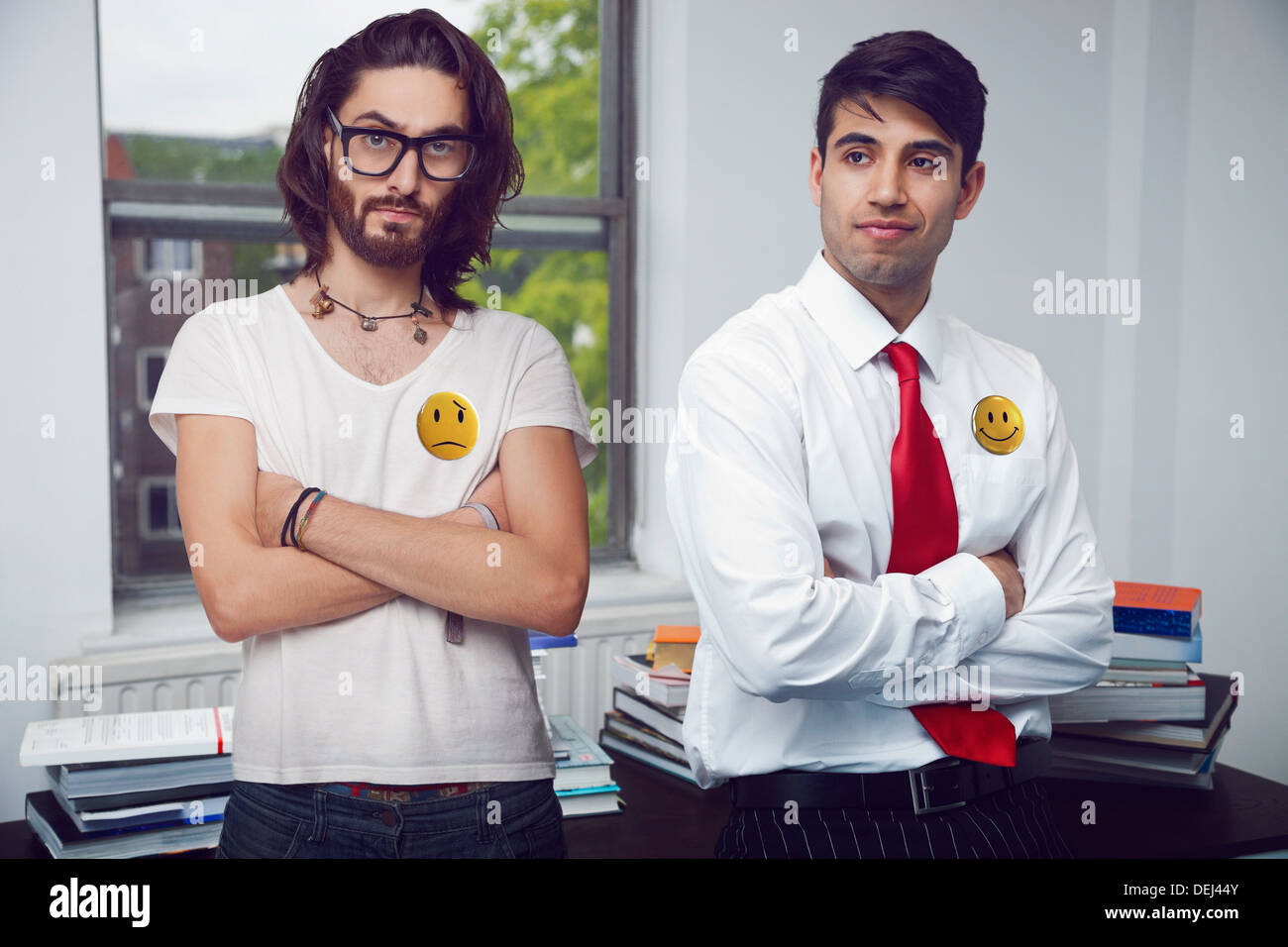 Two men an office folding their arms Stock Photo - Alamy