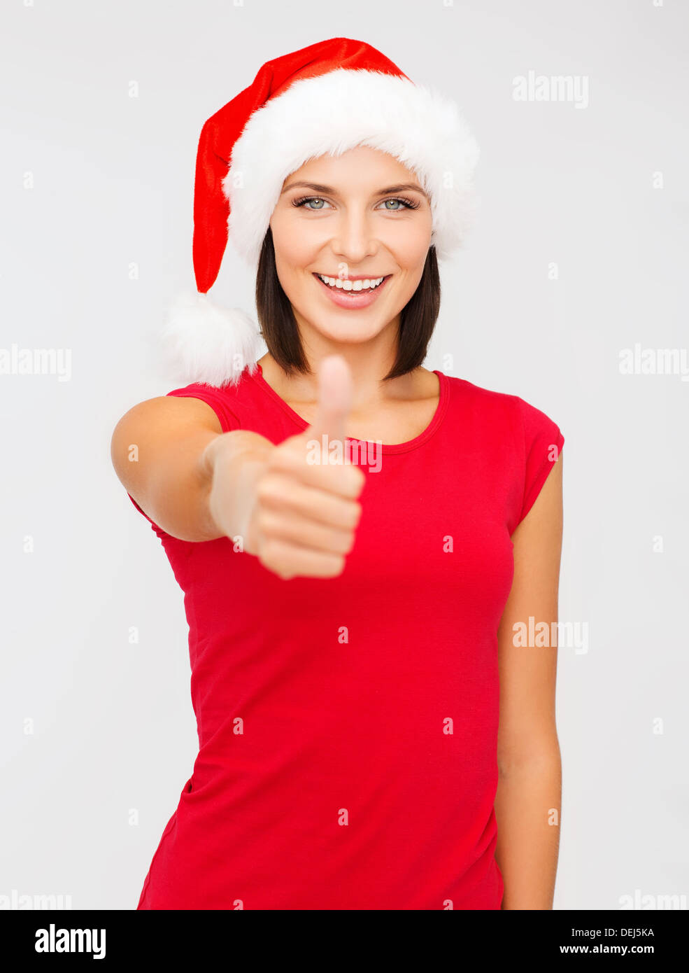 woman in santa helper hat showing thumbs up Stock Photo - Alamy