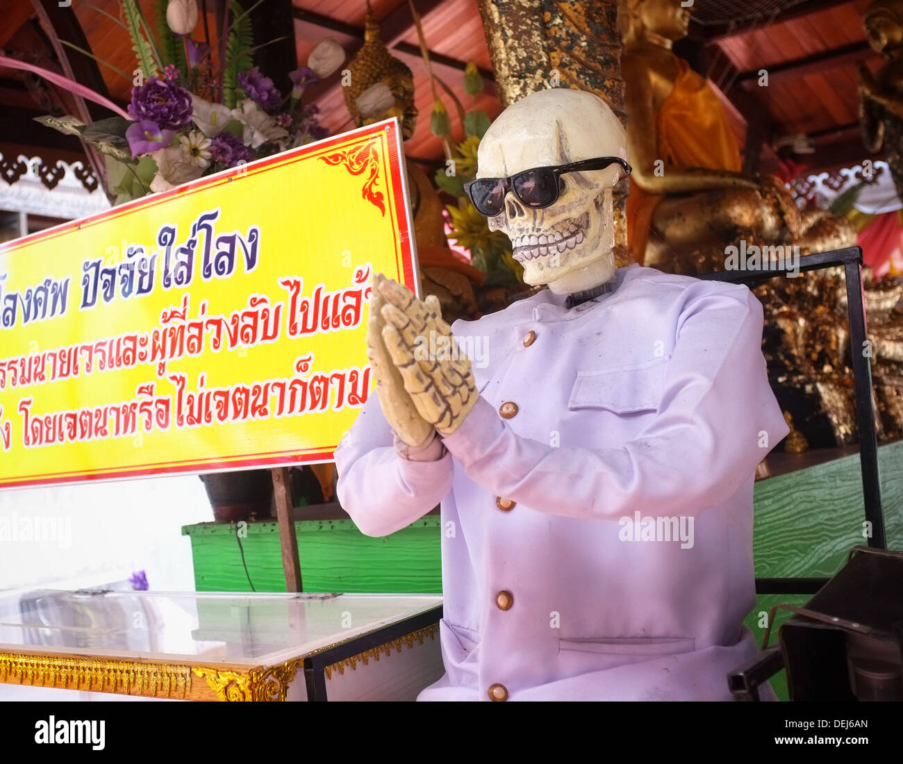 A skeleton solicits charitable donations for funerary expenses at a ...
