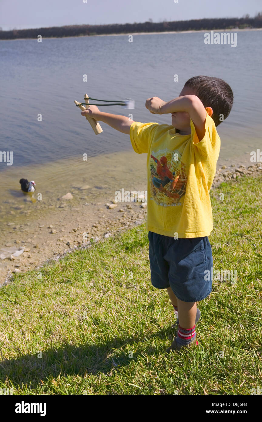 Boy aiming with slingshot hi-res stock photography and images - Alamy