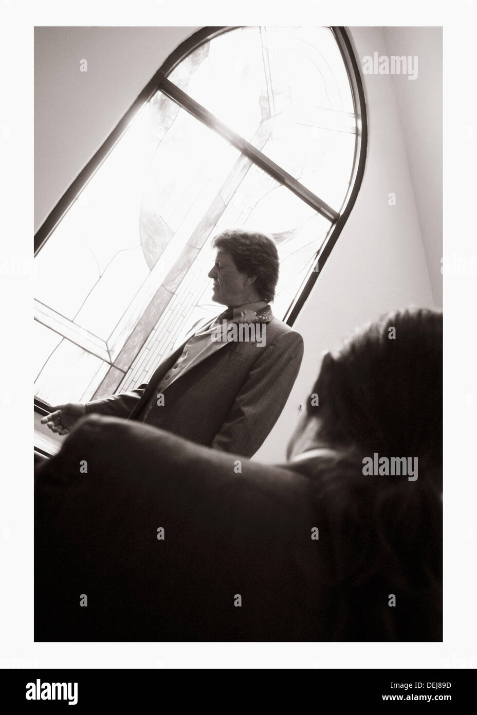 Two people looking out window Cut Out Stock Images & Pictures - Alamy