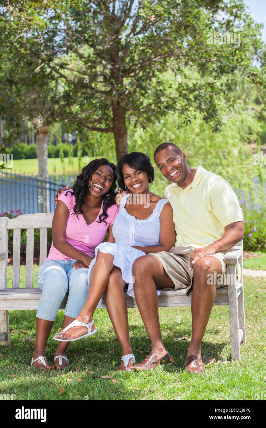 A happy black African American family of two parents and one female ...