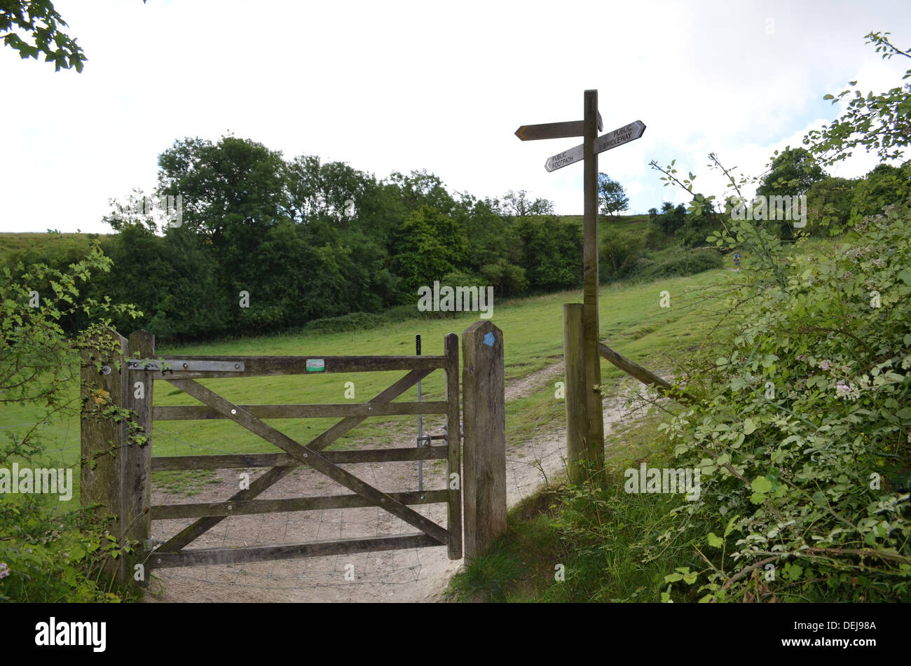 Five bar gate and wooden signpost Stock Photo - Alamy