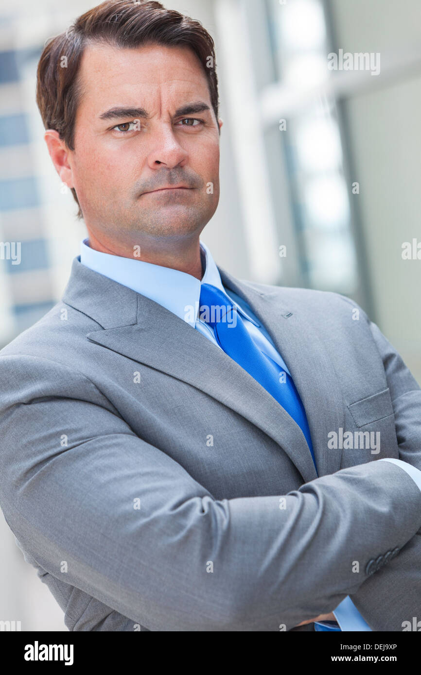 Successful smart businessman or man serious and thinking with arms ...