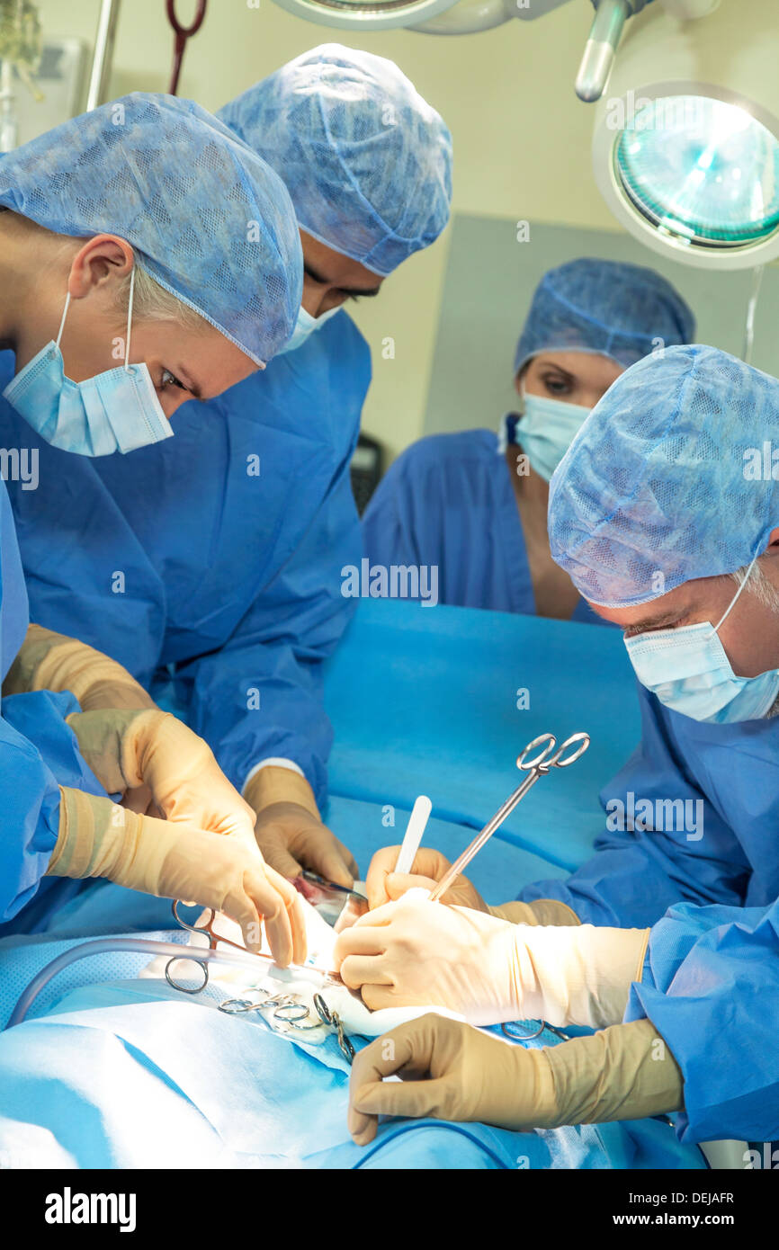 Team interracial medical doctors male female surgeons surgery operating ...