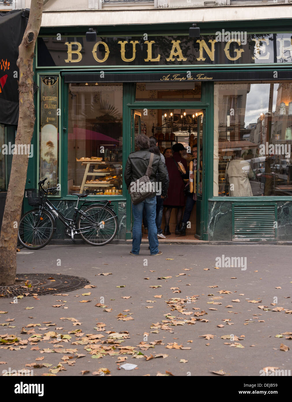 Lunchtime queue for bread at a traditional boulangerie, Paris, France ...
