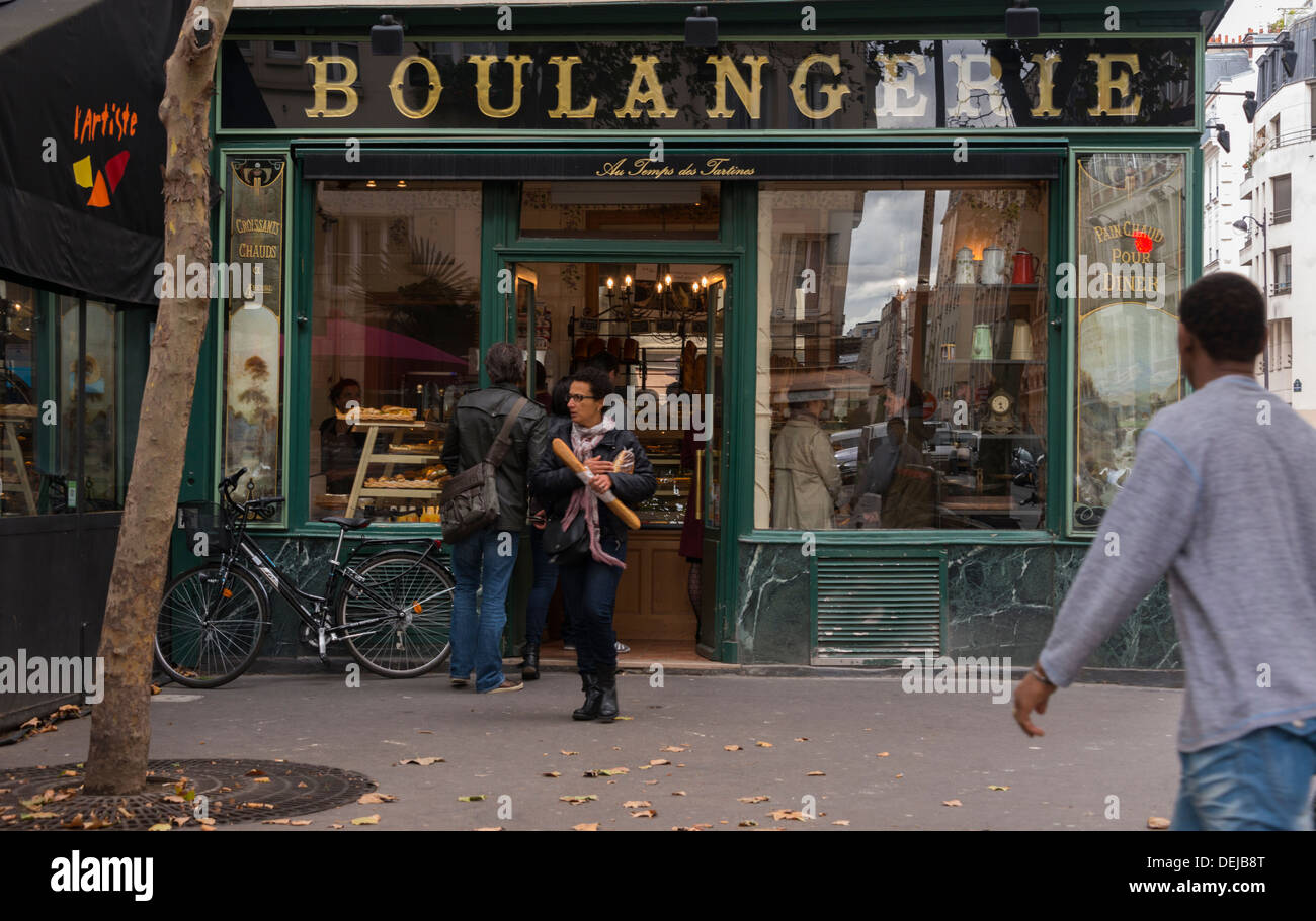 Lunchtime queue for bread at a traditional boulangerie, Paris, France ...