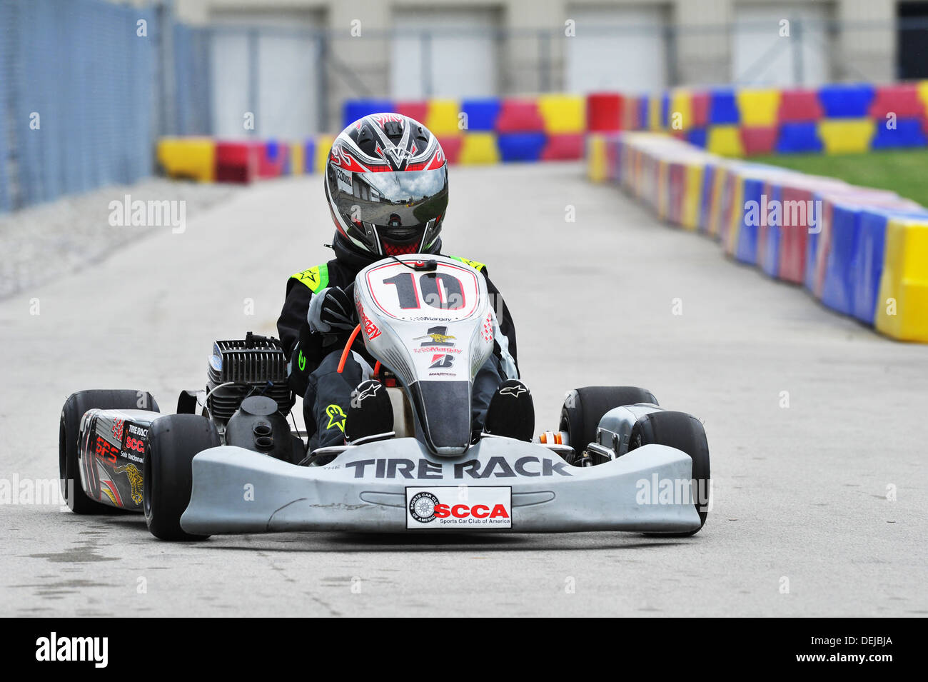 Teenage racer on a Yamaha engined sprint kart on a road racing circuit ...