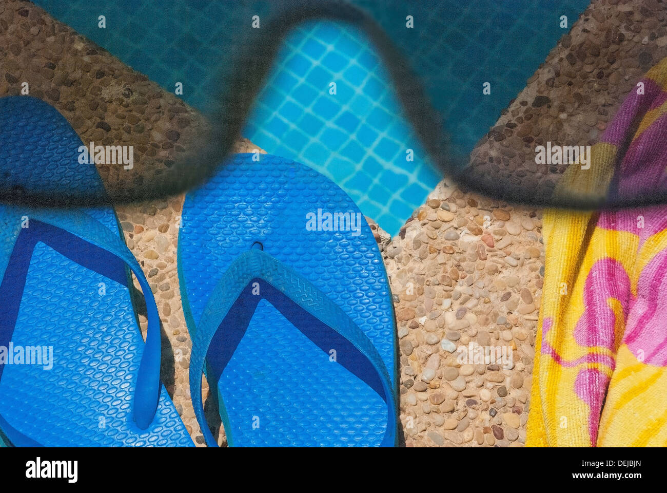 Pool with towel and blue slippers Stock Photo - Alamy