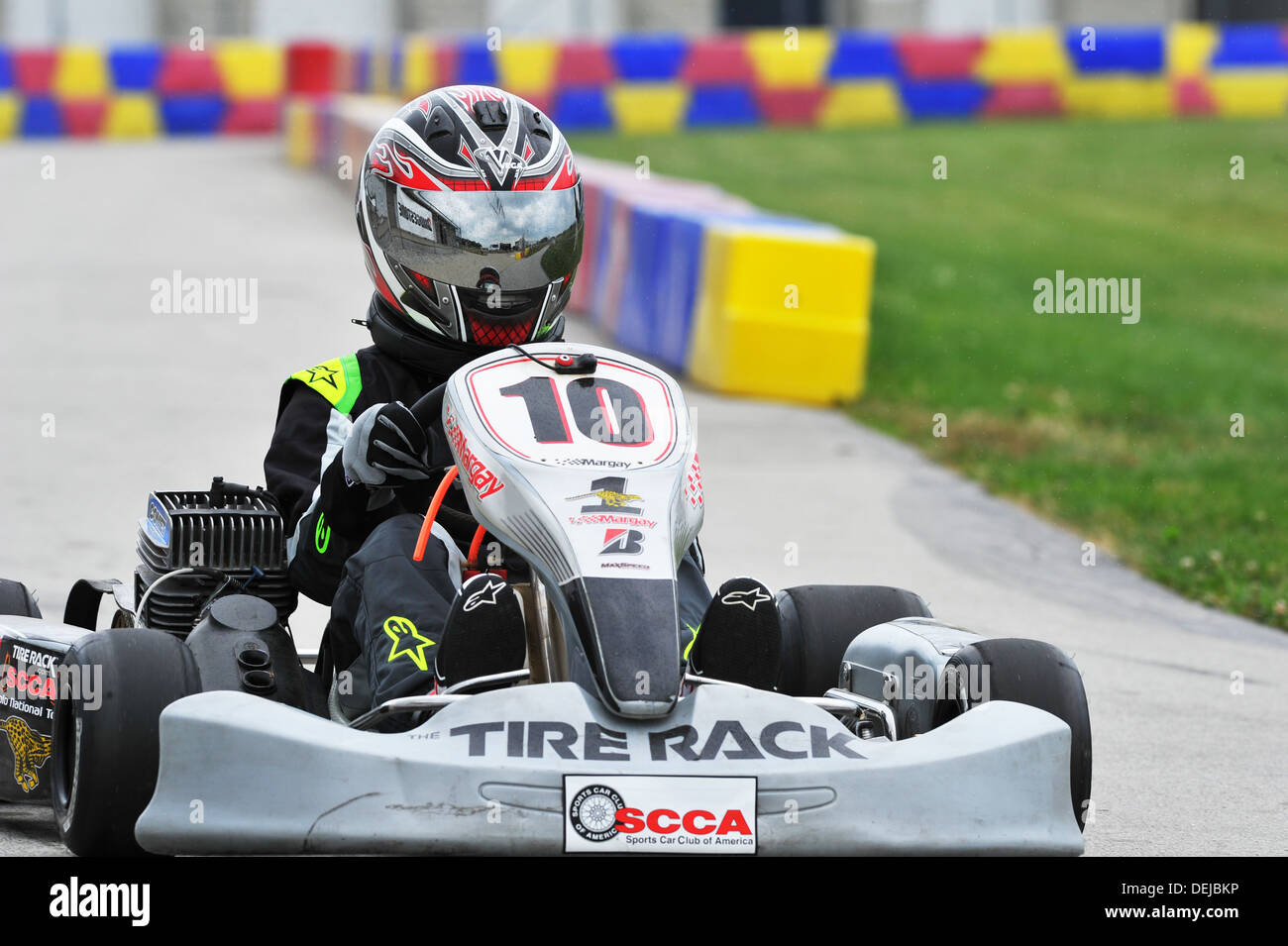 Teenage racer on a Yamaha engined sprint kart on a road racing circuit ...