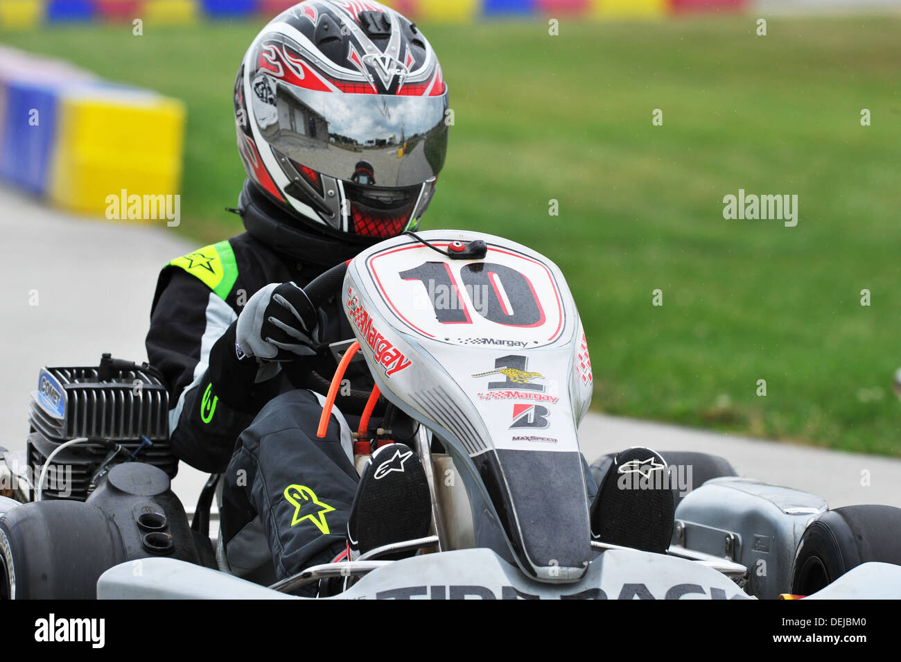 Teenage racer on a Yamaha engined sprint kart on a road racing circuit ...