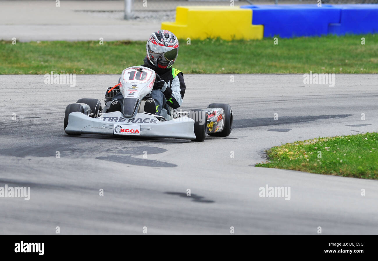Teenage racer on a Yamaha engined sprint kart on a road racing circuit ...