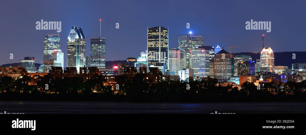 Montreal over river panorama at dusk with city lights and urban ...