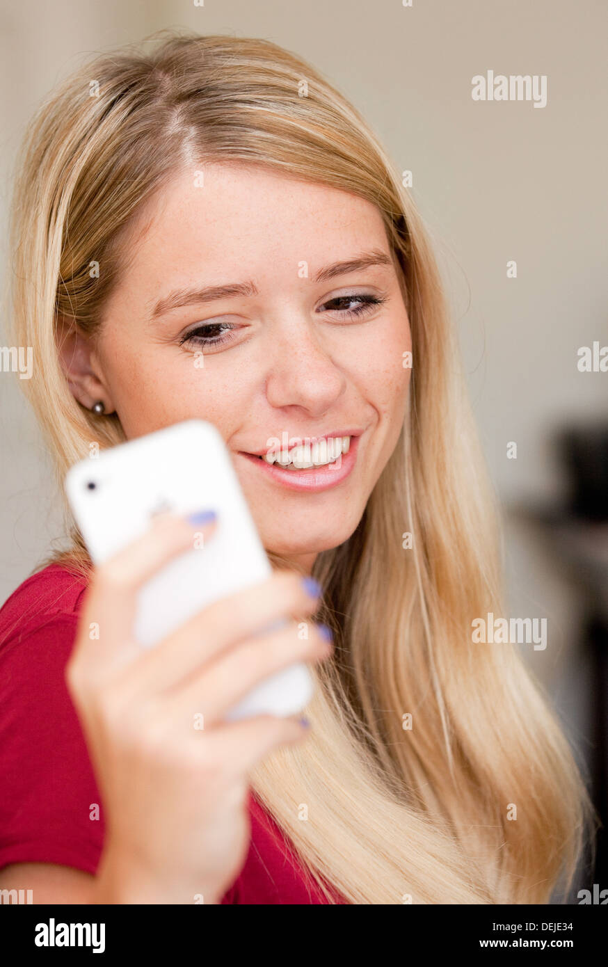 Teenage girl using iPhone taking a photo, UK Stock Photo - Alamy