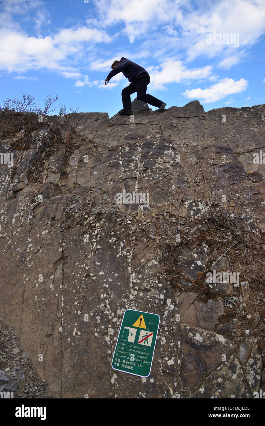 Man ignoring safety warning sign climbs rock wall Stock Photo - Alamy Man ignoring safety warning sign climbs rock wall Stock Photo - Alamy