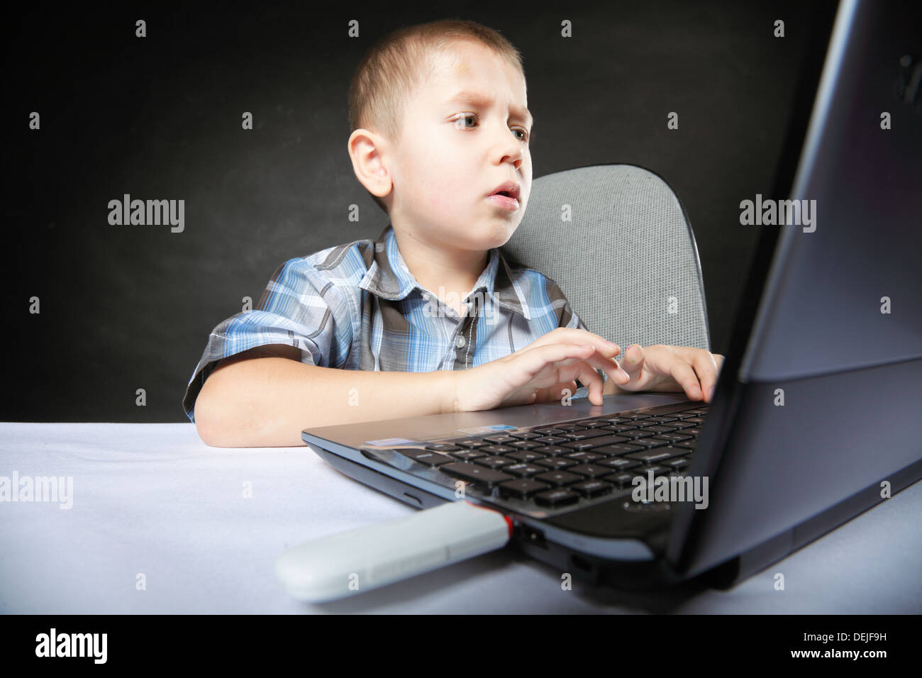 Little kid boy playing on the computer laptop. Technology Stock Photo - Alamy