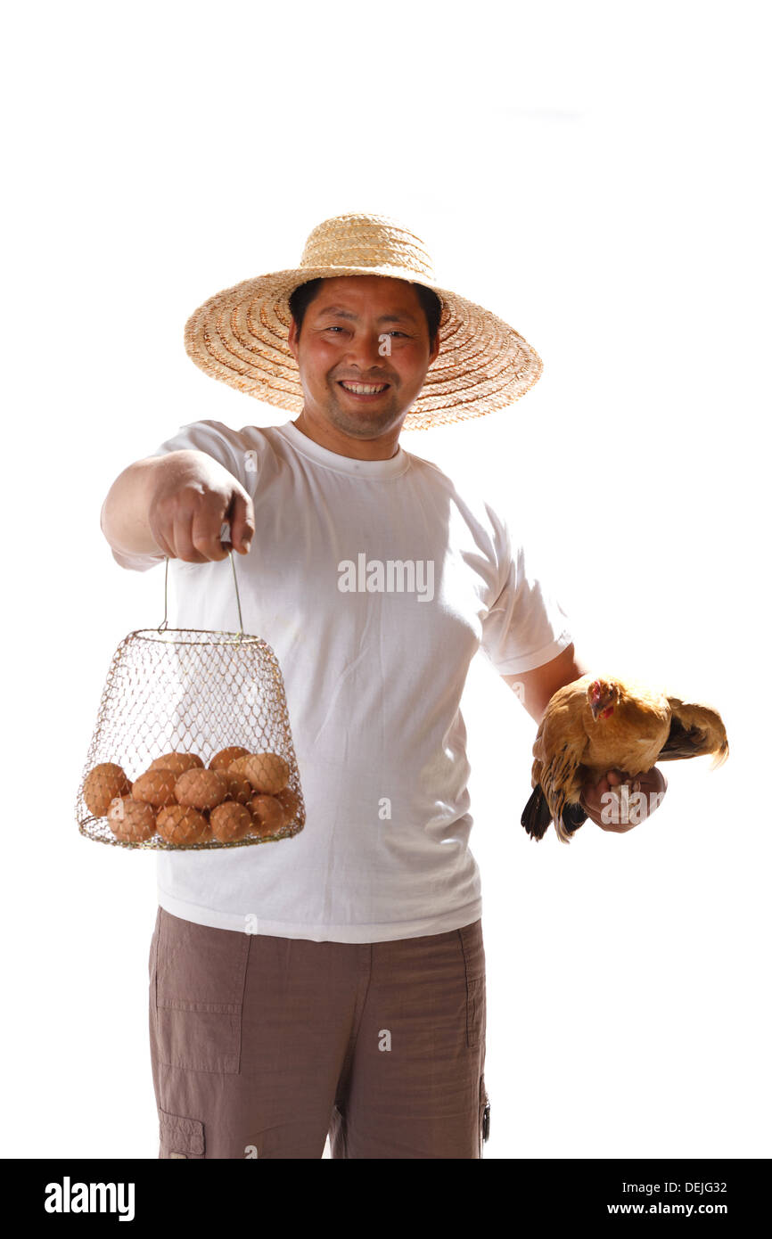 Farmer holding eggs and chicken Stock Photo - Alamy