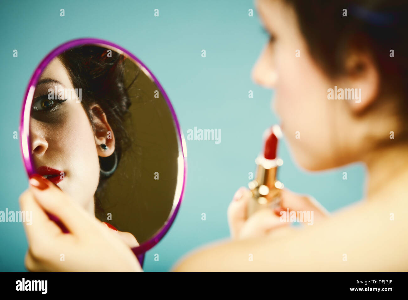 Beautiful young woman with mirror. Make-up and cosmetic. Beauty concept ...