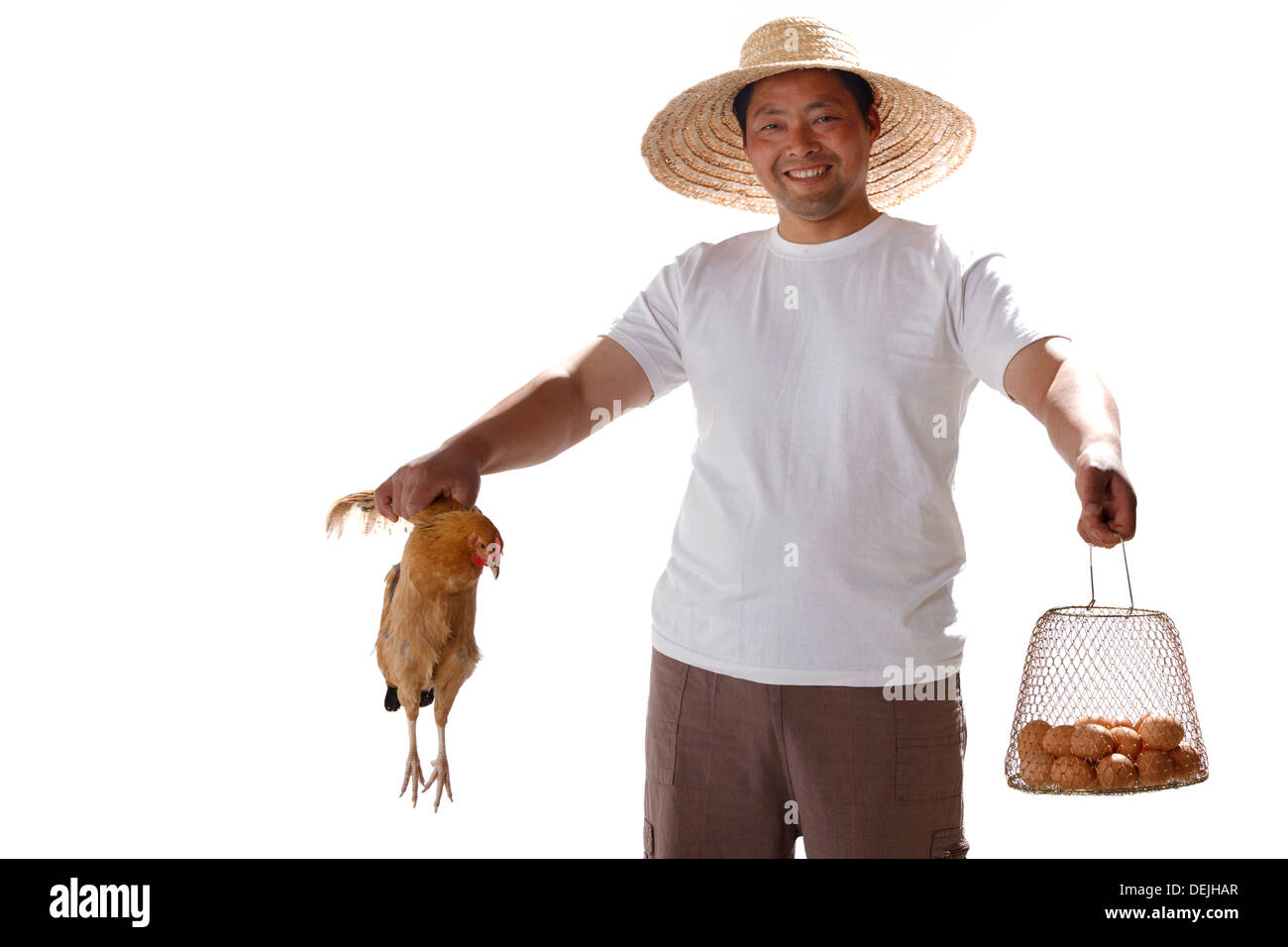 Farmer holding eggs and chicken Stock Photo - Alamy
