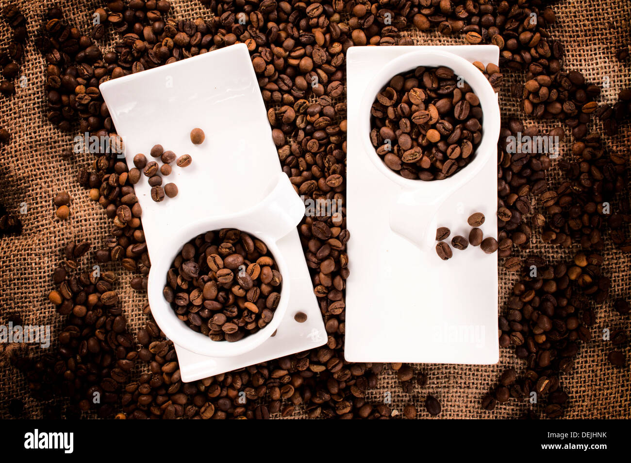 Raw coffee beans in the two white cup from above Stock Photo - Alamy
