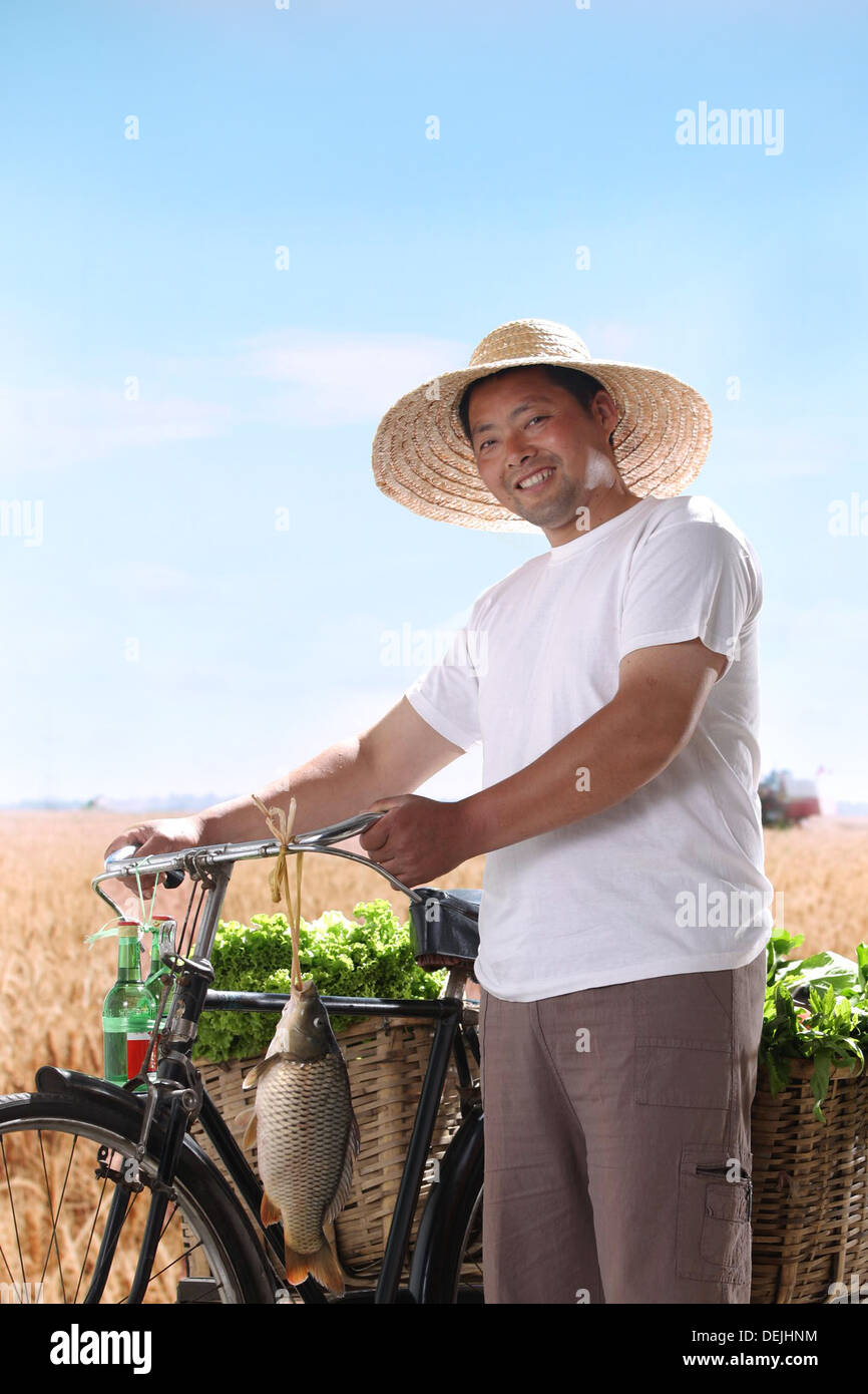 Farmer walking bike with vegetable Stock Photo - Alamy