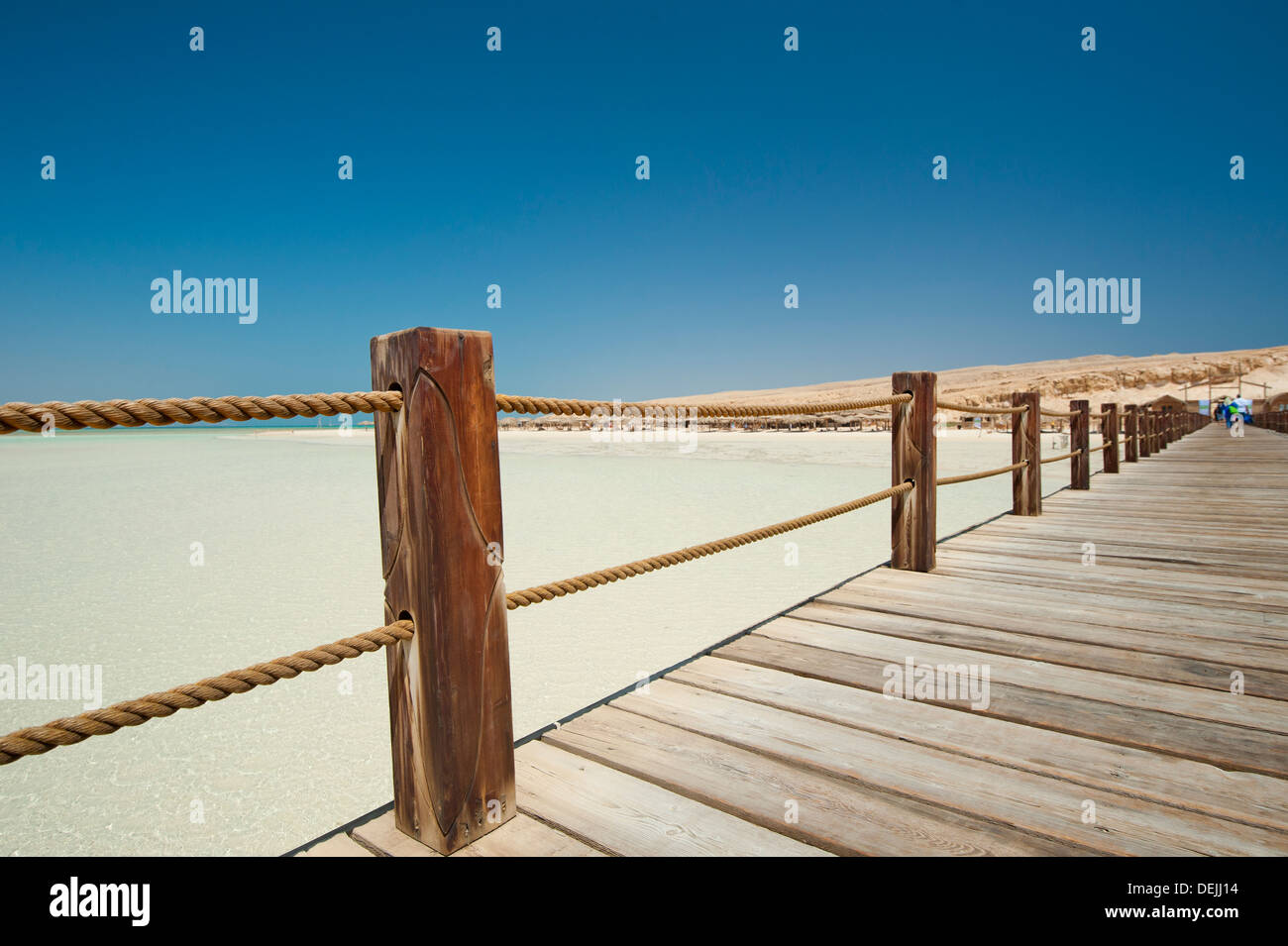 Long wooden jetty on a tropical island stretching into the distance ...