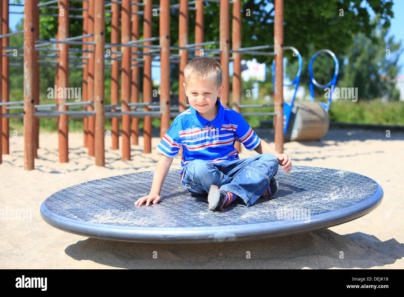 young child boy or kid playing in playground on leisure equipment Stock ...