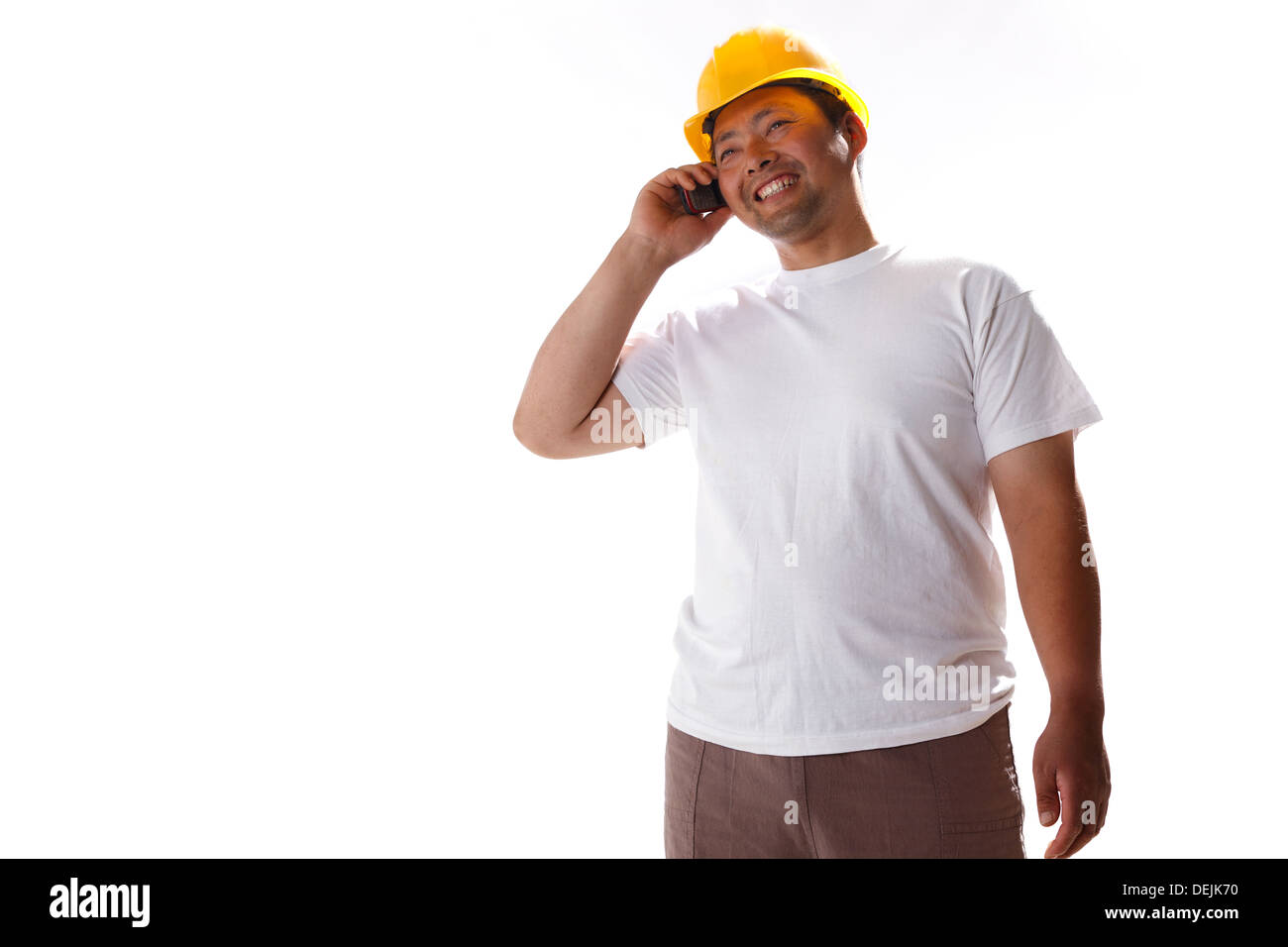 Building worker making phone call Stock Photo - Alamy