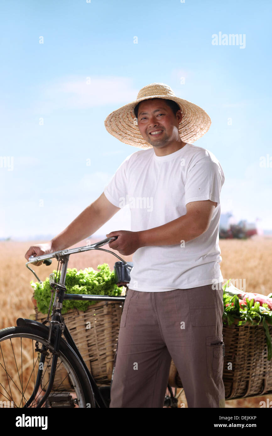 Farmer walking bike with vegetable Stock Photo - Alamy