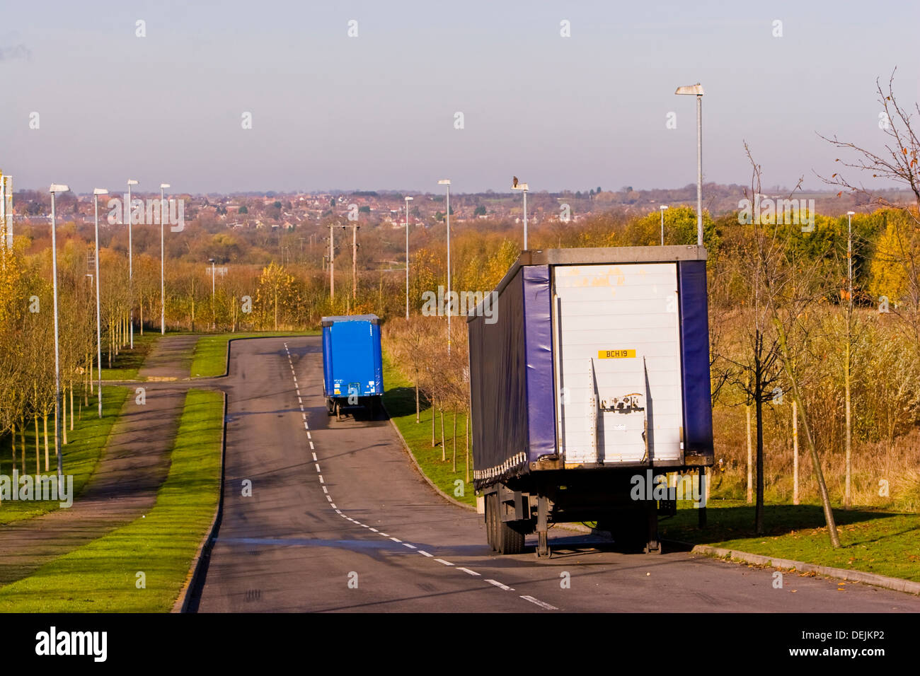 Lorry trailers parked up at the side of the road of an industrial park ...