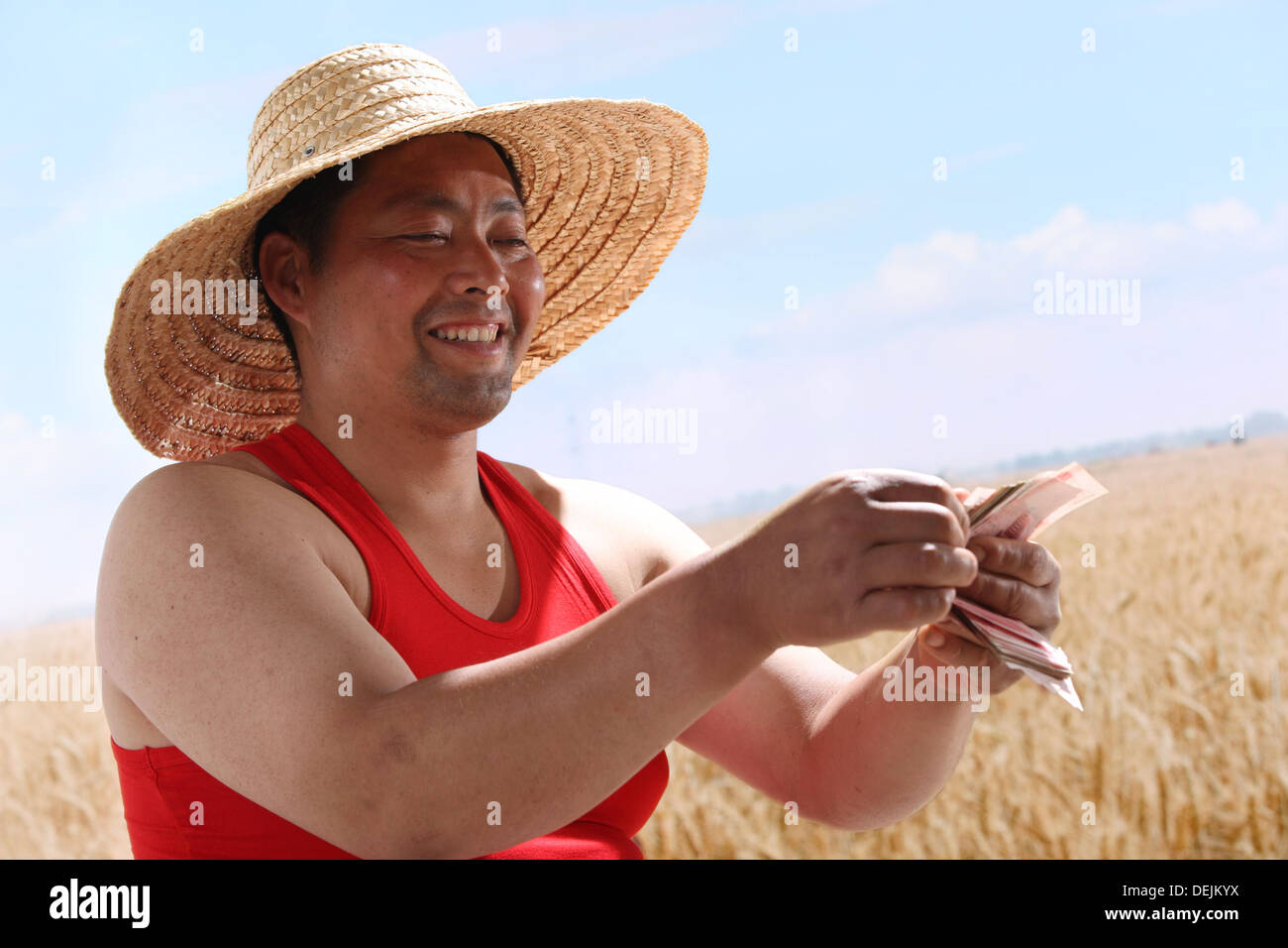 Farmer counting money in field Stock Photo - Alamy