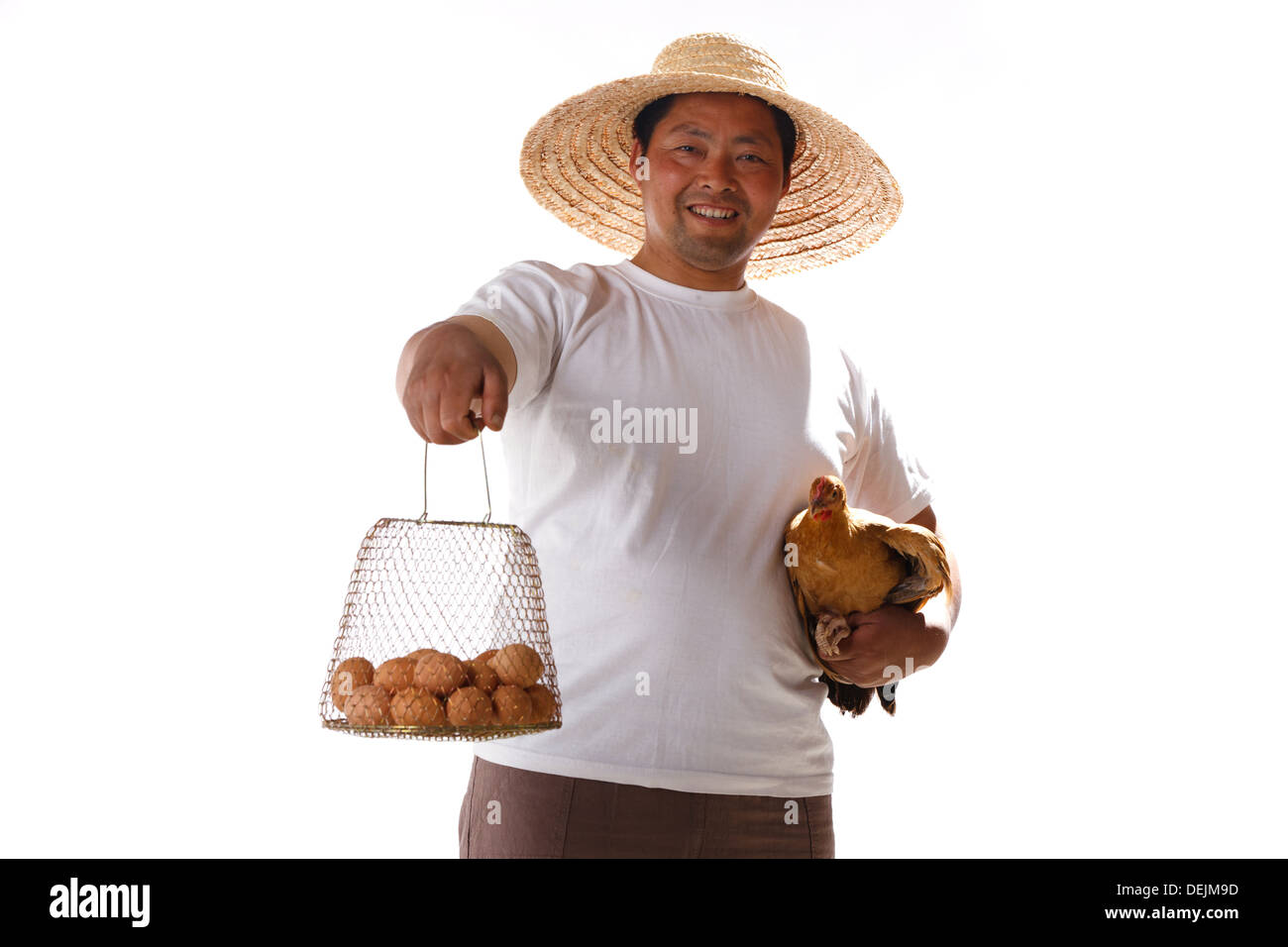 Farmer holding eggs and chicken Stock Photo - Alamy
