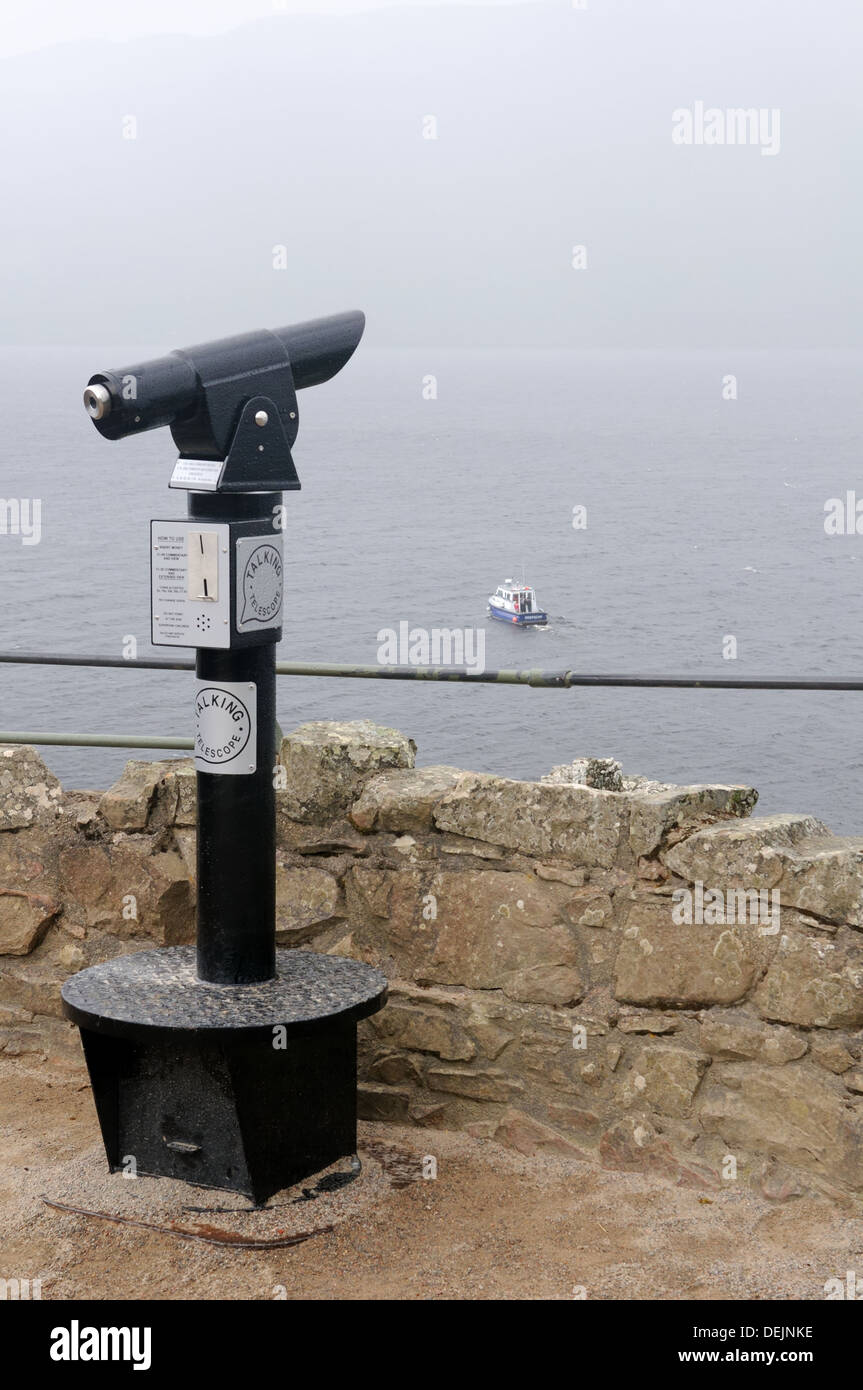 A talking telescope pointing over a small boat on Loch Ness Stock Photo ...