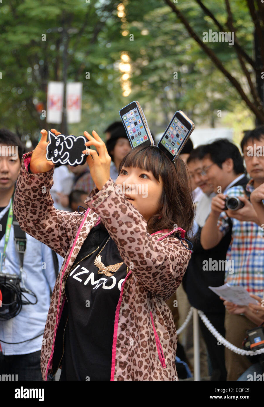 Tokyo, Japan - A Japanese woman with an iPhone braid takes a snap shot ...