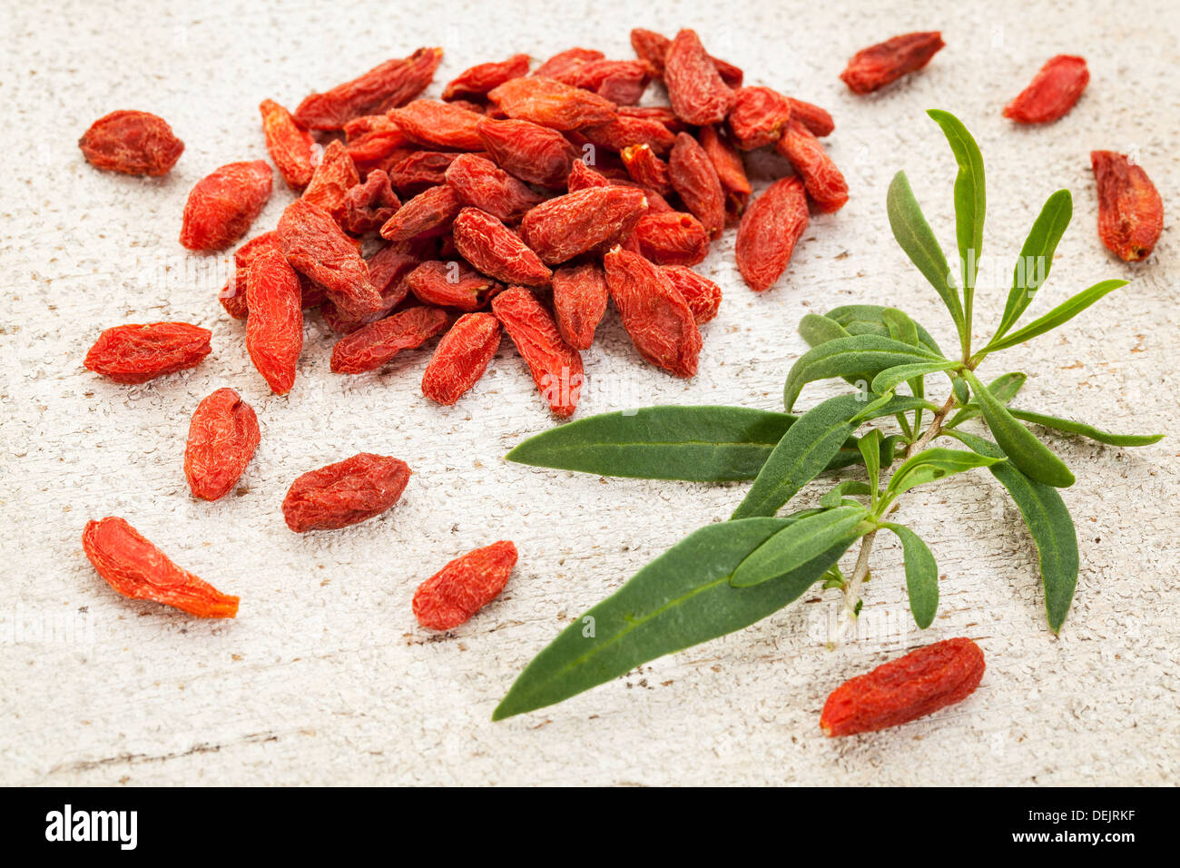 dried Tibetan goji berries (wolfberry) with a fresh goji leaf on white ...