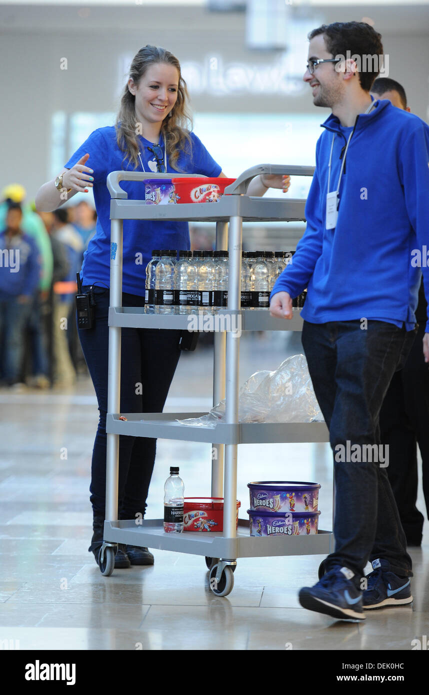 Cardiff, Wales, UK. 20th Sept, 2013. An Apple employee gives drinks and ...