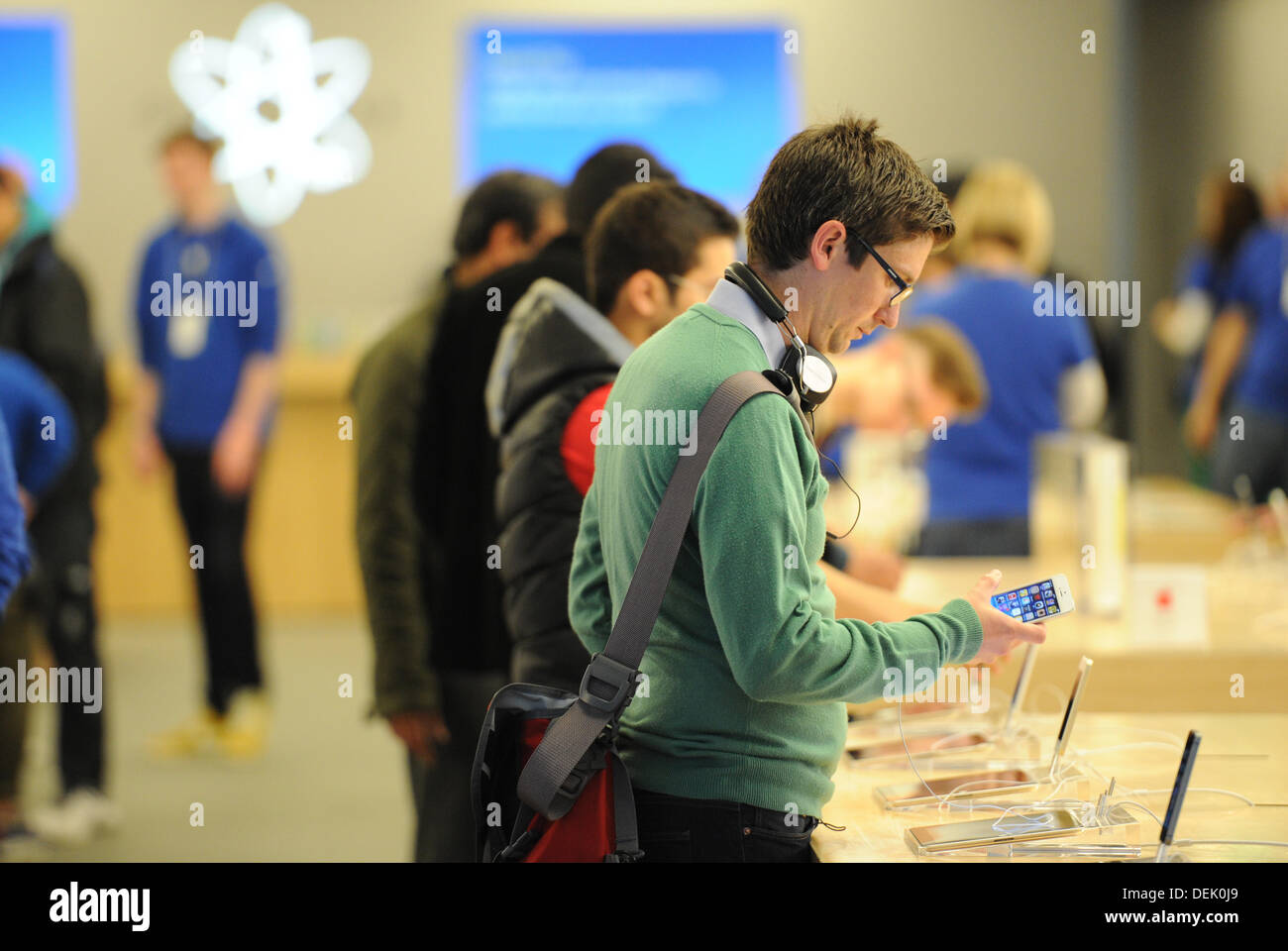 Cardiff, Wales, UK. 20th Sept, 2013. A customer looks at the new iPhone ...