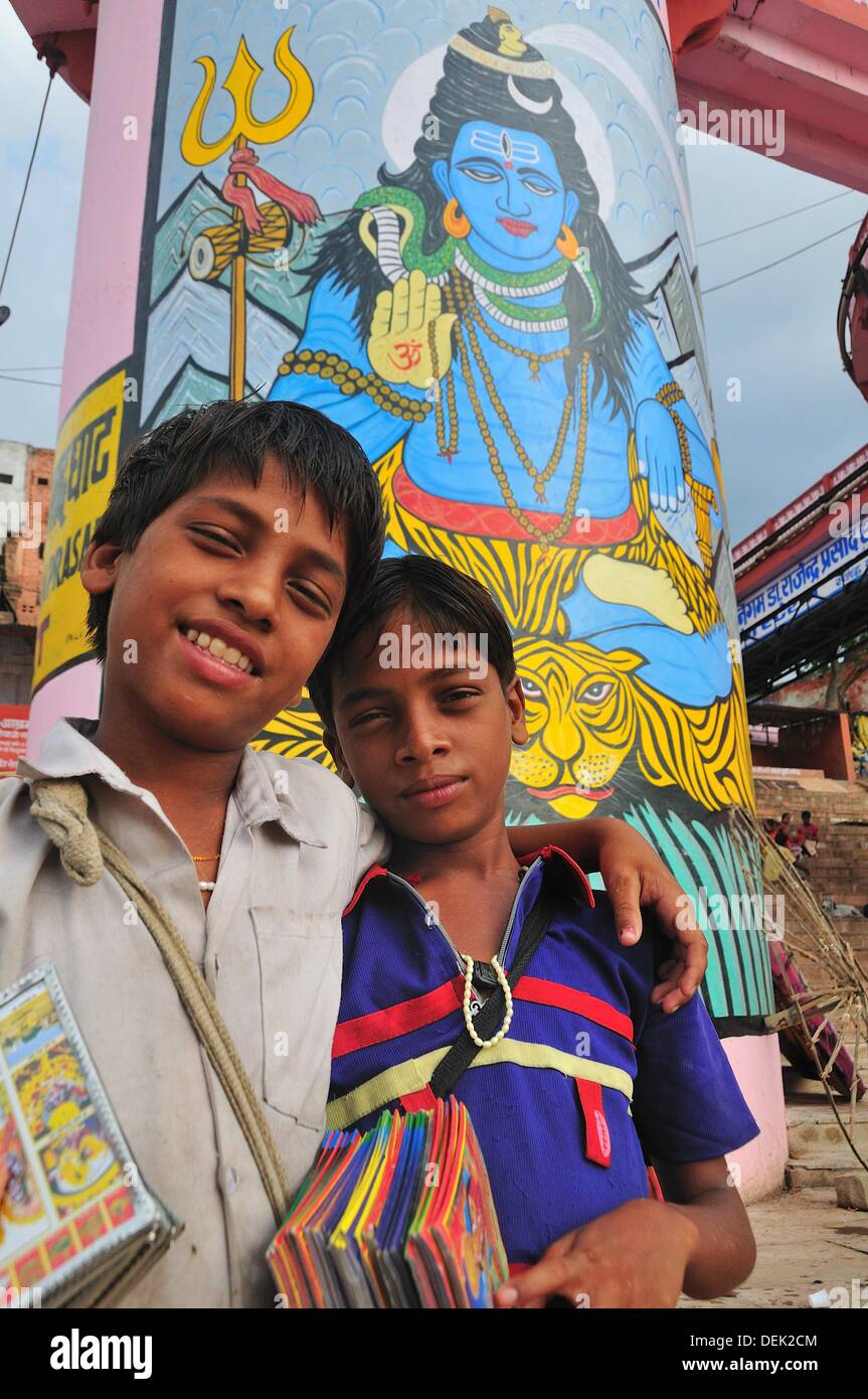 Young brothers selling post card all day long at the ghat by the Ganges ...