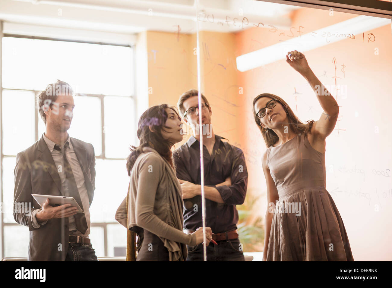 Business people writing on glass wall Stock Photo - Alamy