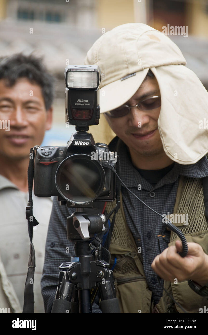 Chinese photographer and his Nikon camera Stock Photo - Alamy