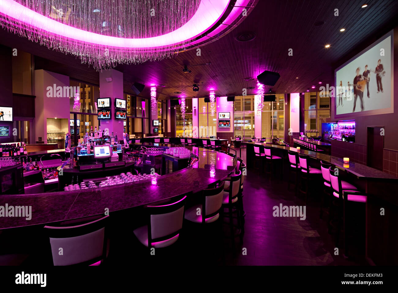 Empty nightclub illuminated with purple neon light Stock Photo - Alamy