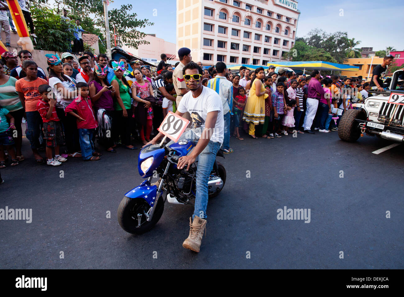 Man riding bike entertaining crowd in a carnival, Goa Carnivals, Goa ...
