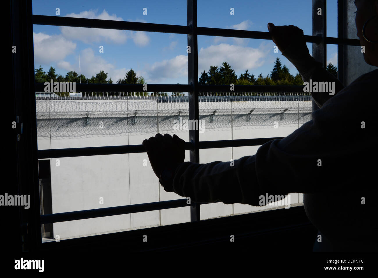 Ravensburg, Germany. 19th Sep, 2013. A female inmate poses at a barred ...