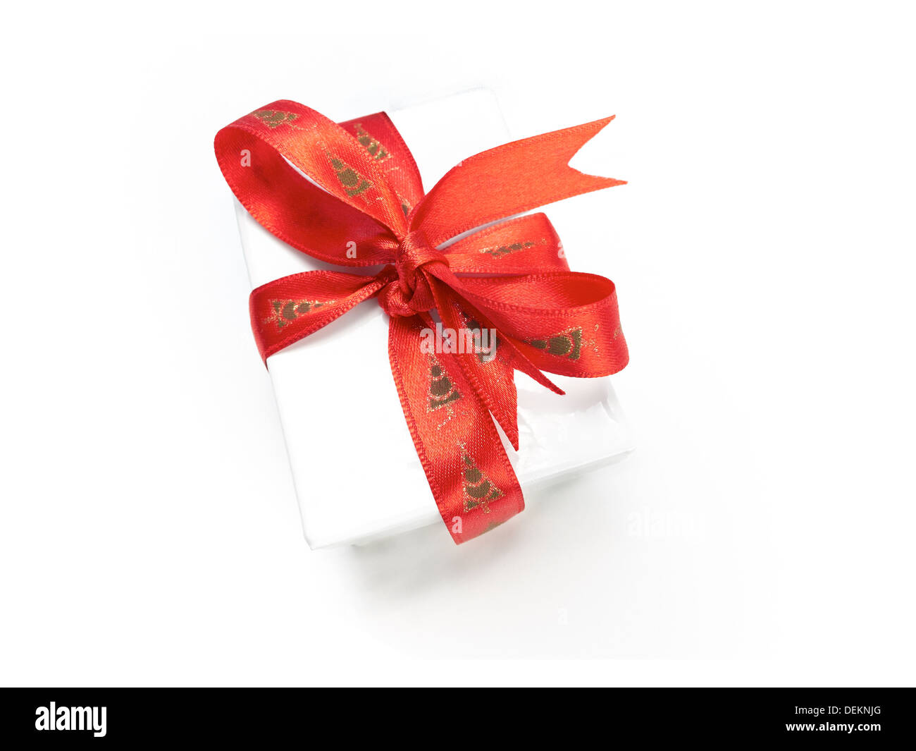 A wrapped Christmas present with a colourful red ribbon bow on a white ...