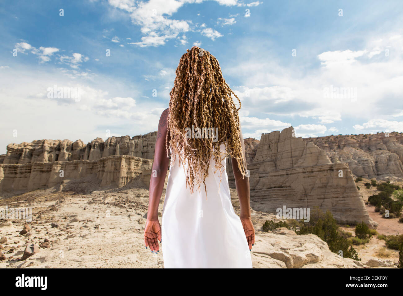 African American woman examining rock formations, Santa Fe, New Mexico ...